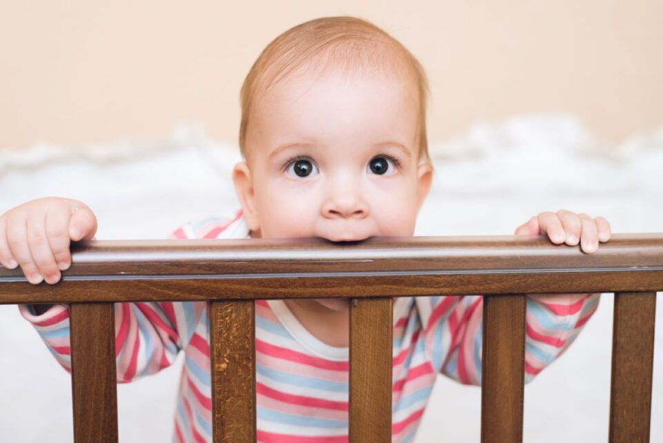 Baby Chewing On A Crib: Is She Playing Or Teething?